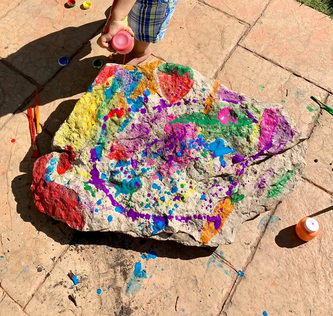 Alicia painting rocks - My Bored Toddler