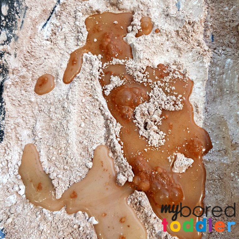 Taste safe muddy dinosaur sensory bin - My Bored Toddler
