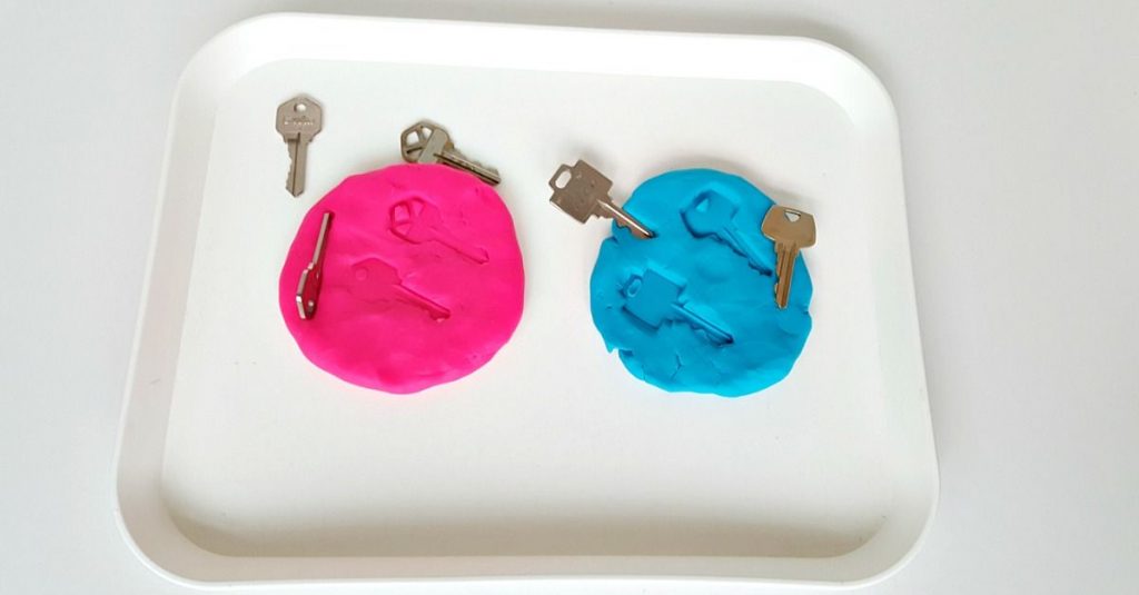 Fine Motor with Keys in Play Dough - My Bored Toddler