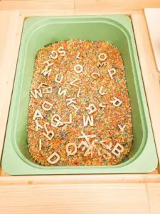 Danielle - ABC sensory bin colored pasta and wooden letters. Lamintaed ...