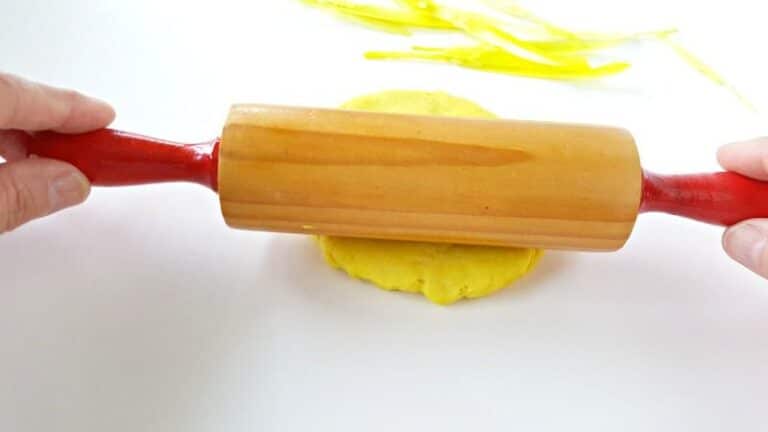 Flatten playdough with a rolling pin - My Bored Toddler